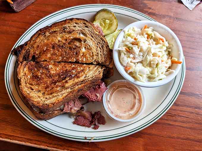 This isn't just a sandwich, it's an engineering marvel of perfectly grilled rye supporting a skyscraper of corned beef, sauerkraut, and melty Swiss.