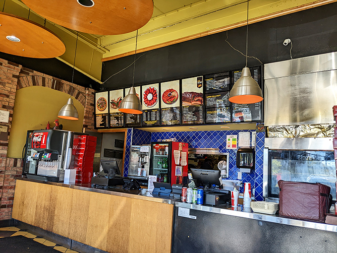 Where the magic happens! The counter area buzzes with activity as orders fly and the aroma of perfectly seasoned chicken fills the air.