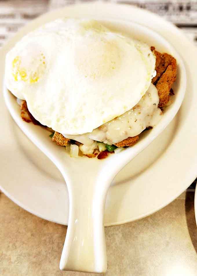 This country fried steak skillet is the breakfast of champions &ndash; crispy, savory, and topped with a perfectly runny egg.
