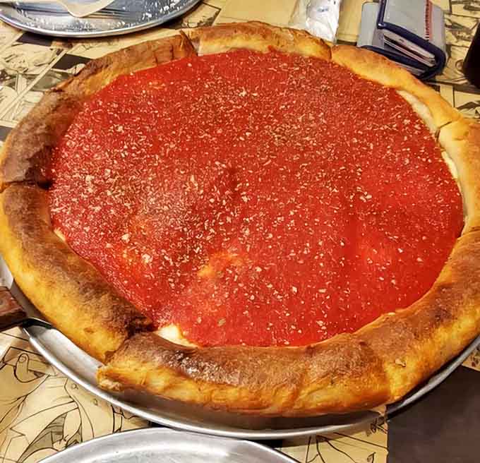 Chicago-style deep dish in all its glory &ndash; a fortress of flavor with walls of golden crust containing a lake of bright tomato sauce.