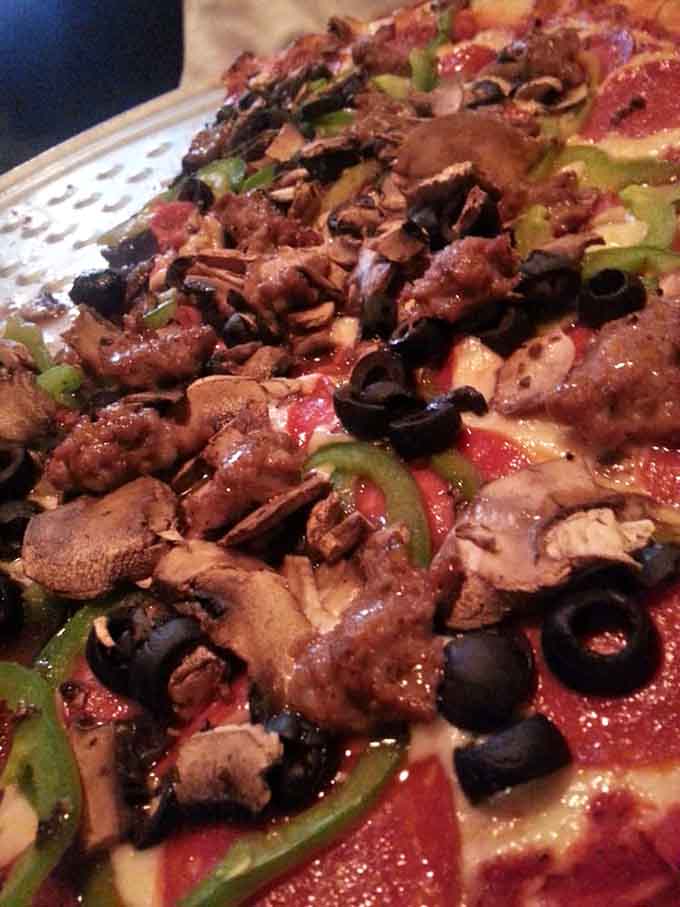 Italian sausage scattered across melted mozzarella like edible confetti at the world's best party.