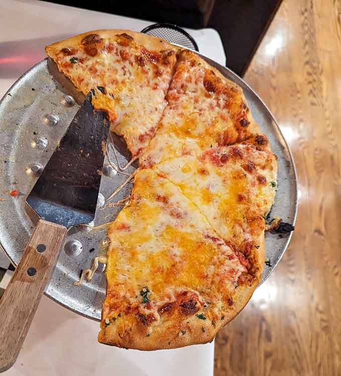 Behold the perfect New York-style slice: thin, foldable, and sporting that ideal cheese-to-crust ratio that makes pizza purists weep with joy.