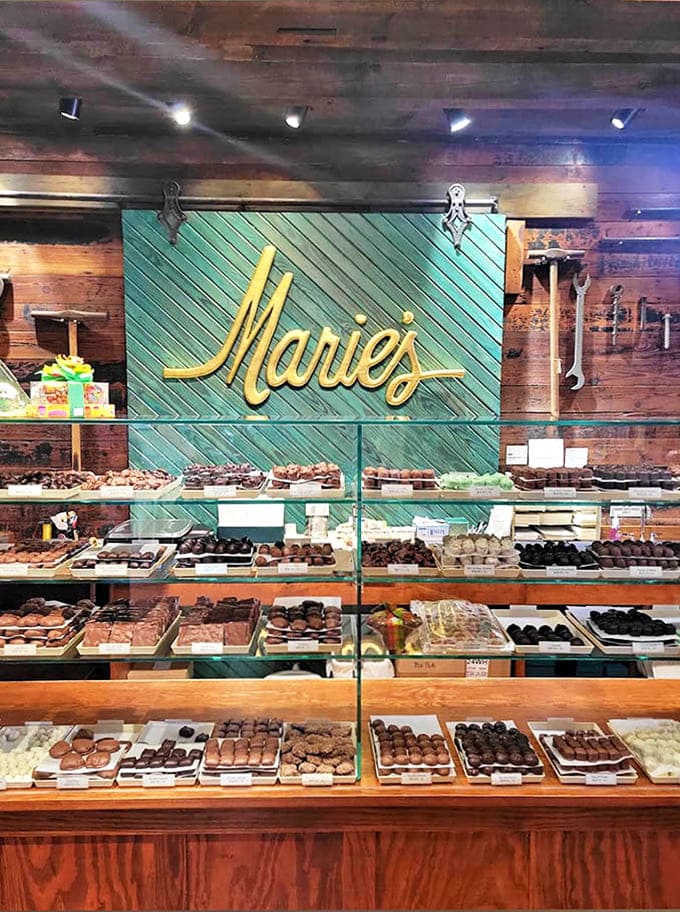 Behind gleaming glass lies a chocolate wonderland where each piece is displayed like the edible artwork it truly is.