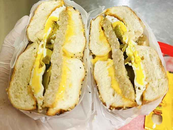 Behold the breakfast sandwich in its natural habitat, stuffed with eggs and cheese that ooze like they're auditioning for a food commercial.