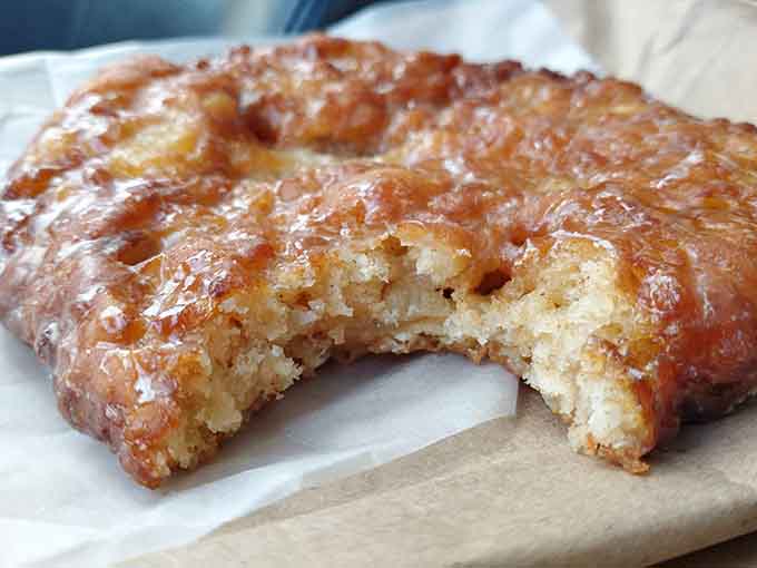 Behold the apple fritter in all its golden glory, a palm-sized masterpiece that's earned worldwide acclaim one bite at a time.