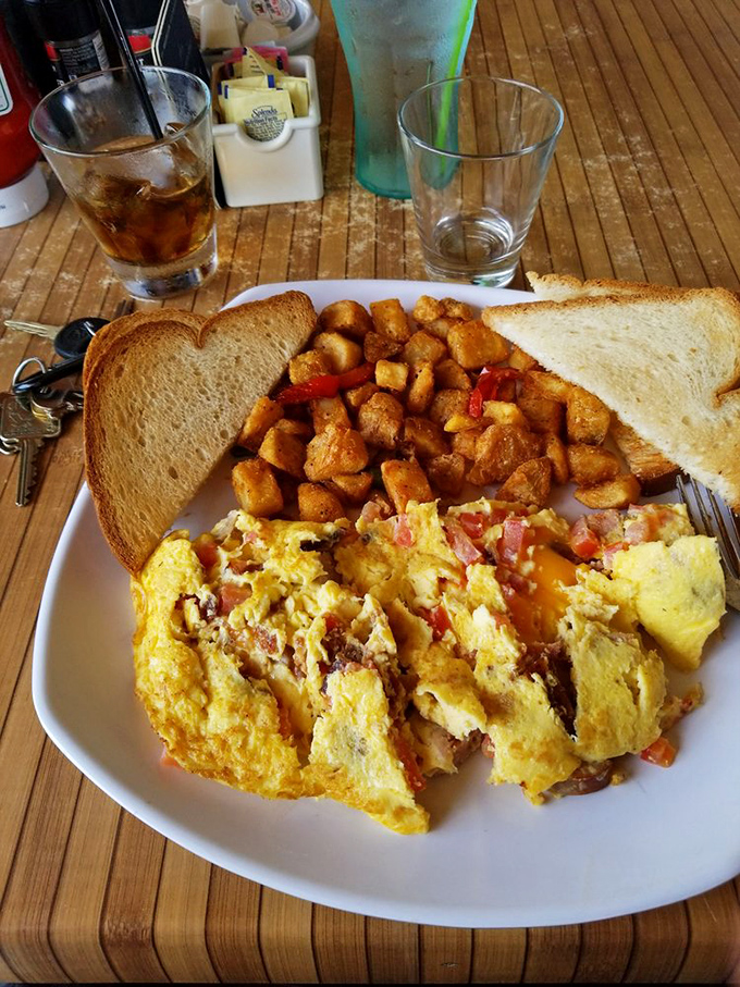 Morning glory on a plate: a hearty omelet stuffed with savory ingredients alongside golden home fries makes breakfast worth waking up for.