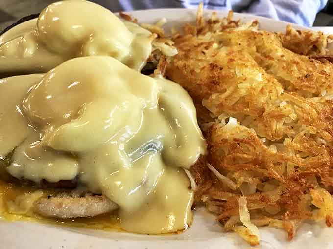 Eggs Benedict and Hash Browns: Hollandaise cascading over perfectly poached eggs meets crispy hash browns &ndash; breakfast's power couple in their finest form.