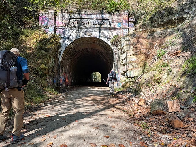 Hikers approach the historic tunnel, where every step echoes with both personal footfalls and the whispers of railroad history.
