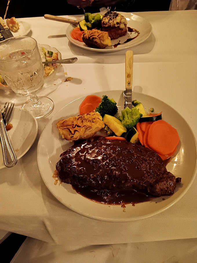 This isn't just a steak &ndash; it's a masterclass in beef preparation. The filet mignon glistens under its cabernet glaze, promising butter-knife tenderness and profound flavor.