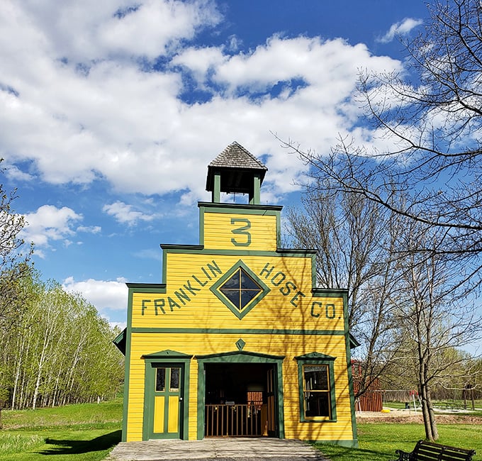 The sunshine-yellow Franklin Hose Company brightens the landscape, a cheerful reminder of when firefighting required serious elbow grease.