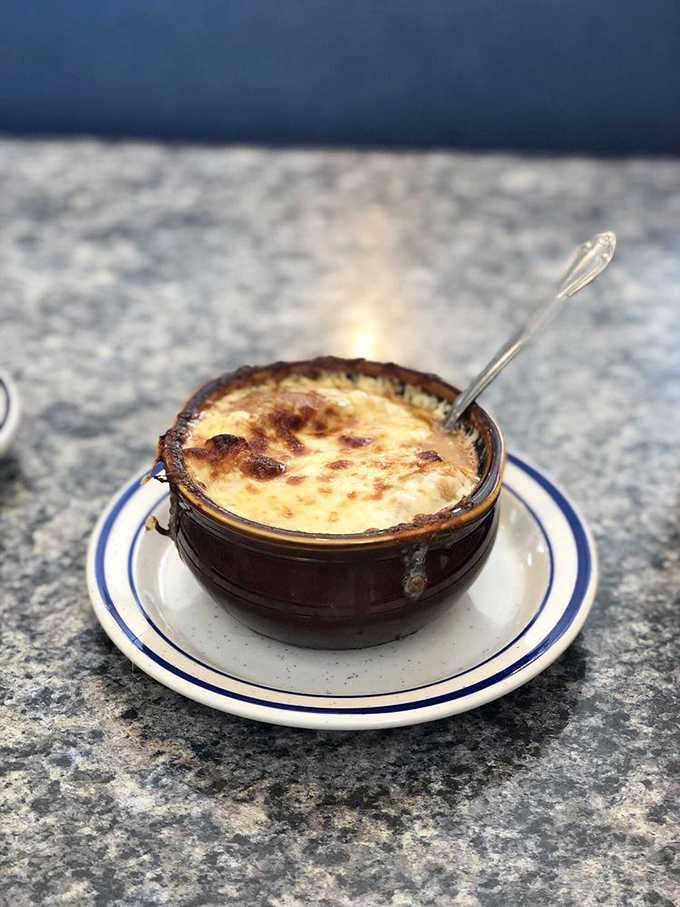 This isn't just soup &ndash; it's a French onion masterpiece with a cheese cap so perfect it deserves its own security detail.