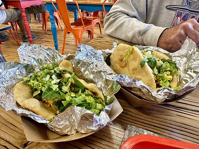Golden pillows of fry bread cradle fresh toppings like a mother holding her newborn &ndash; except this baby is delicious and socially acceptable to devour.