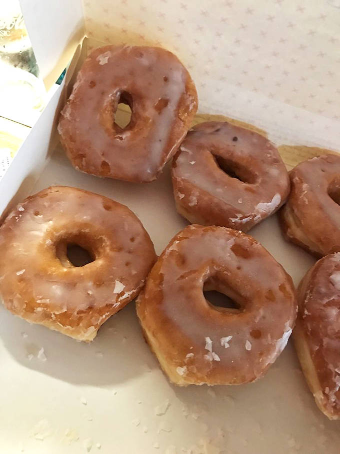 These glazed beauties aren't just donuts; they're time machines to a simpler era when perfect execution trumped flashy innovation.