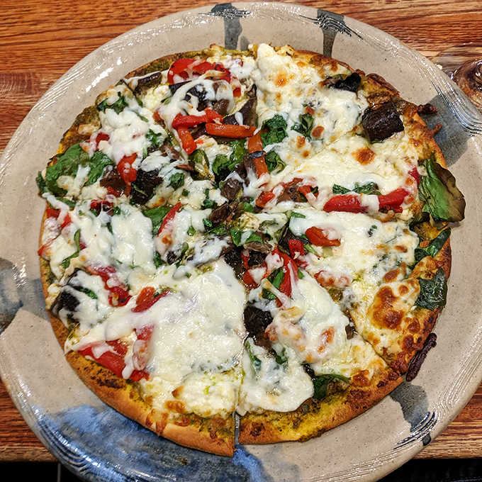 This veggie-packed pizza isn't just gluten-free, it's flavor-full! Look at those roasted red peppers and spinach playing so nicely together.