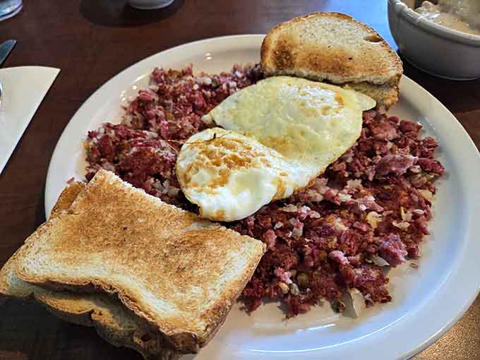 Corned beef hash so tender and flavorful it could make a vegetarian reconsider their life choices, topped with perfectly cooked eggs.