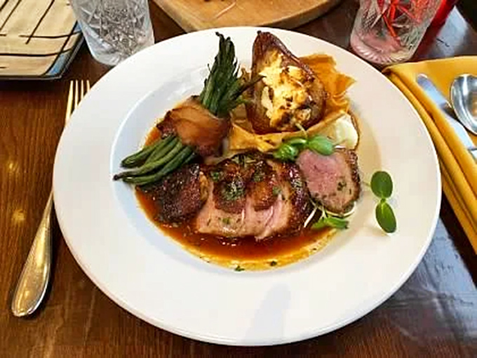 Herb-seared duck medallions that would make a French chef weep with joy. The sauce isn't just poured&mdash;it's carefully painted across the plate like edible art.