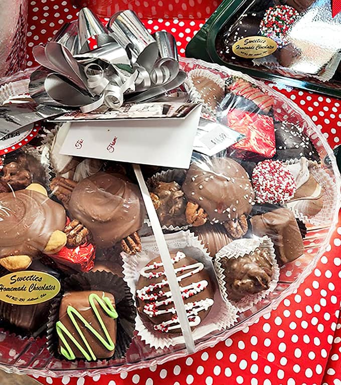 Handcrafted chocolates nestle in their crystal-clear display, each piece a miniature masterpiece that's almost too beautiful to eat. Almost.