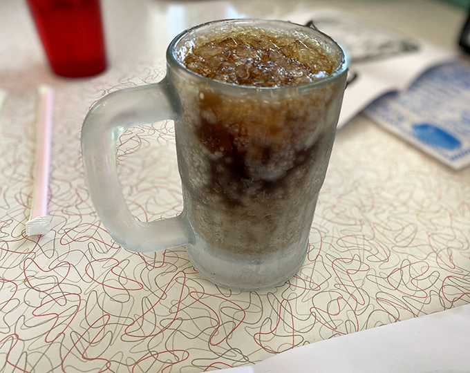 Liquid nostalgia in a glass – the homemade root beer arrives so cold it's practically smoking, promising sweet relief from the desert heat.