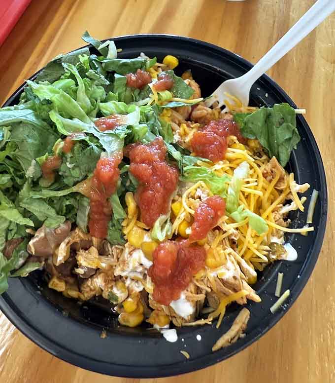 This burrito bowl is a masterpiece of layered flavors, with fresh lettuce, seasoned protein, and toppings that play together beautifully.