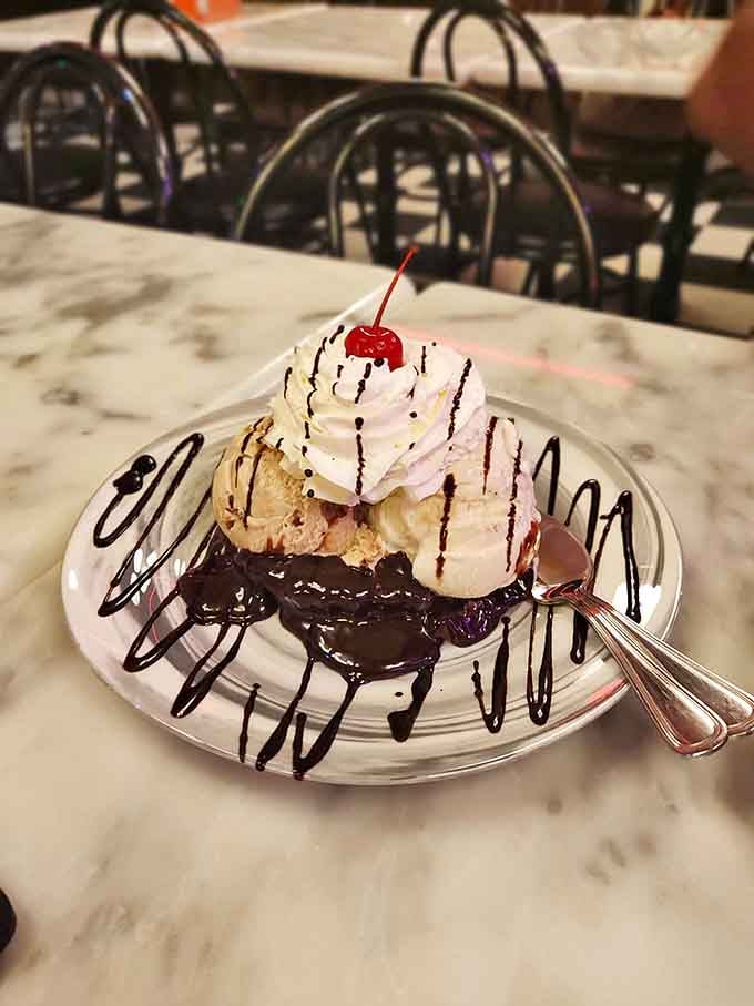 This isn't just dessert &ndash; it's architecture. A towering monument to the belief that chocolate sauce should never be applied conservatively.