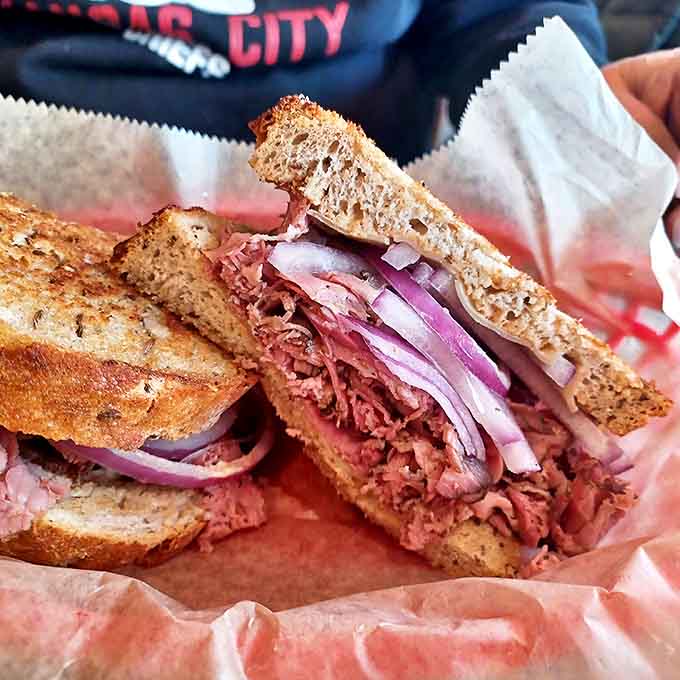 Behold the tower of tender, hand-sliced corned beef nestled between rye bread &ndash; a masterpiece that requires both strategy and napkins to conquer.