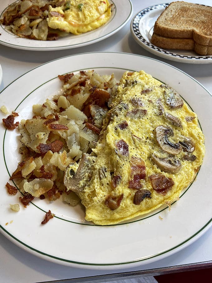 This isn't just any omelet &ndash; the Lorraine comes packed with mushrooms and cheese, paired with perfectly crispy home fries that'll make your morning.