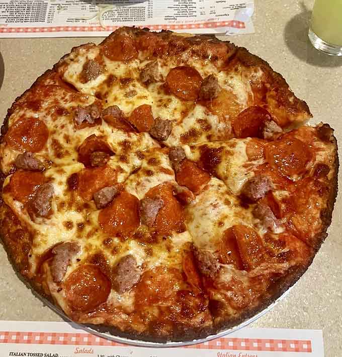 That pepperoni and sausage pizza shows exactly why Luigi's has survived decades while trendier spots come and go.