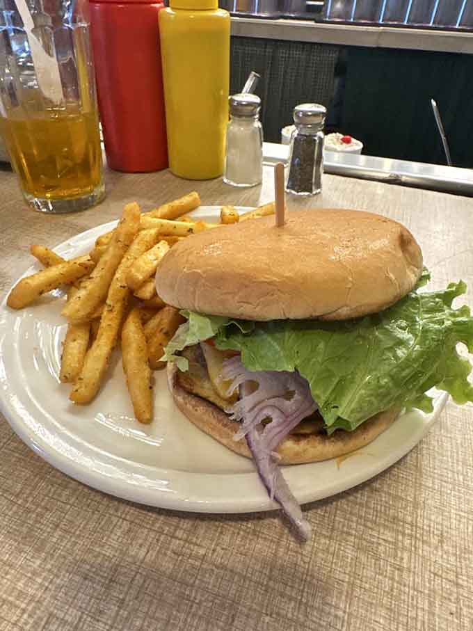 A proper burger with golden fries demonstrates that simple done right beats complicated done wrong every single time.