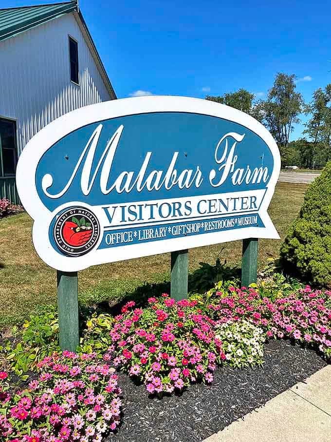 The welcoming blue sign greets visitors with promises of discovery&mdash;gift shop treasures and local history await inside.
