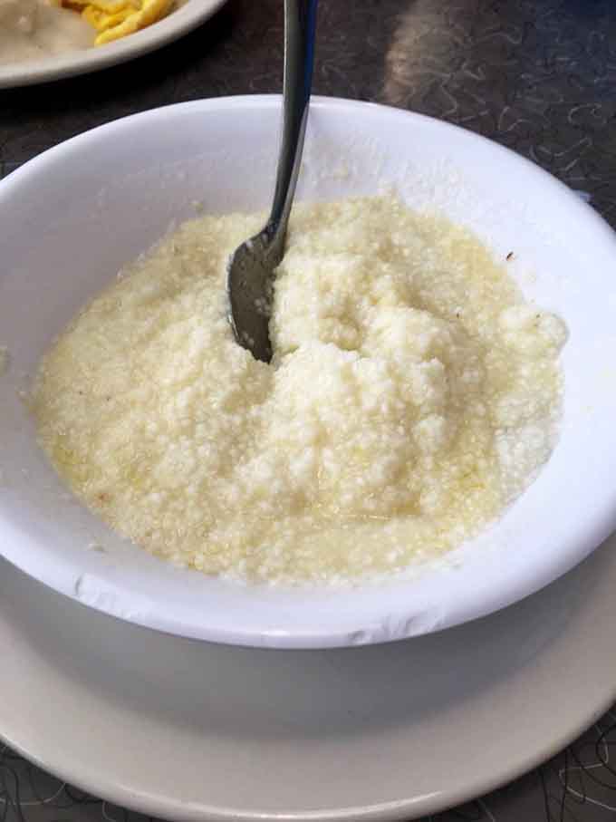 Behold the creamy, buttery perfection that is Mel's homemade grits, cooked slowly until they reach spoon-standing consistency and soul-warming deliciousness.