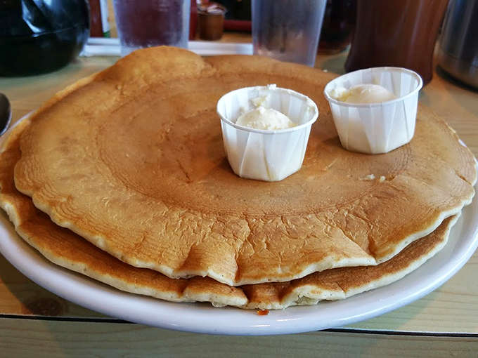 These aren't just pancakes&mdash;they're golden-brown miracles that stretch to the plate's edge, waiting for rivers of warm syrup to transform them.