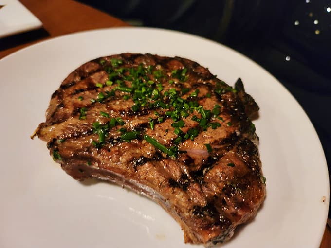Behold the ribeye in all its glory, perfectly seared with those gorgeous grill marks that make steak lovers everywhere swoon.