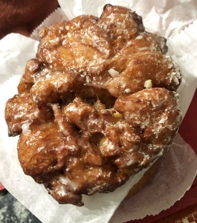 Behold the apple fritter in all its twisted, golden glory, a pastry so magnificent it deserves its own theme song.