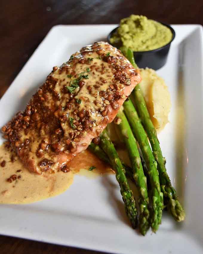 The Pecan Bronzed Salmon arrives like edible art, with that gorgeous crust and perfectly cooked fish that justifies the hype.