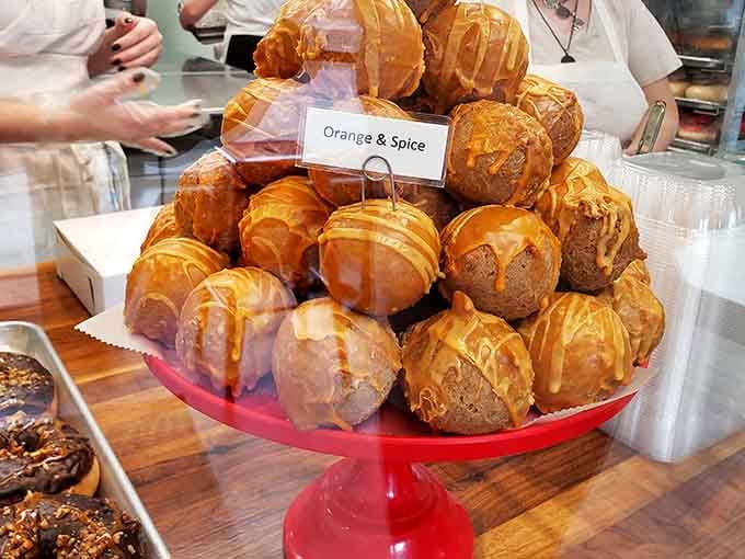 Orange & Spice donut balls stacked in tempting towers &ndash; each one a perfect two-bite explosion of warm cinnamon and bright citrus notes.