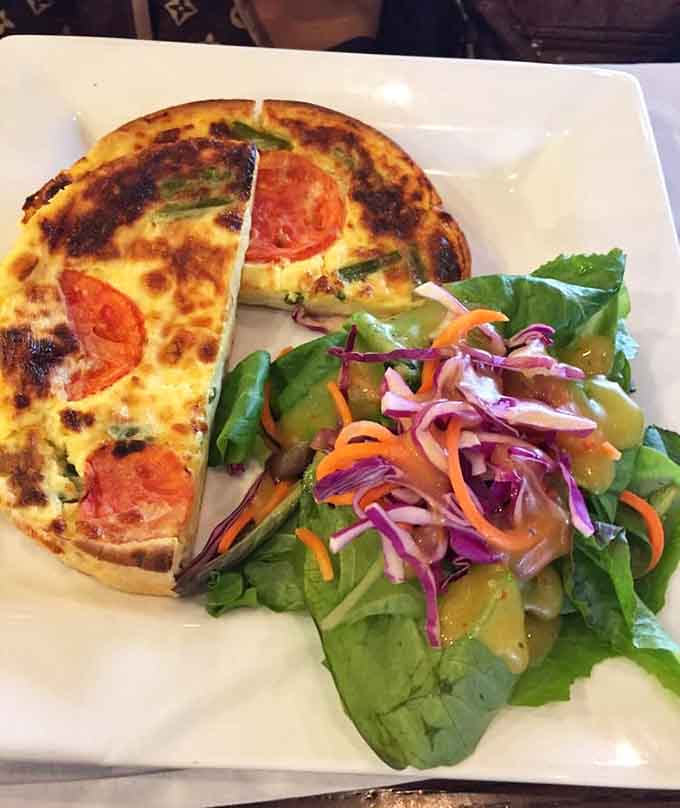 Golden quiches lined up like edible soldiers, each one a different flavor adventure waiting to happen on your plate.