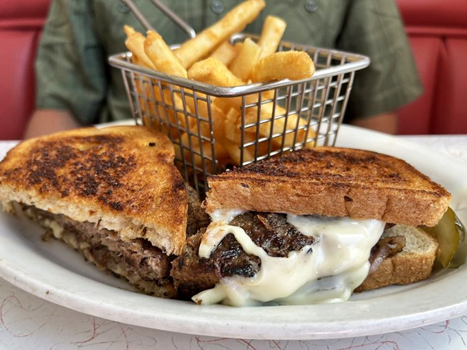 This isn't just a sandwich &ndash; it's a patty melt masterpiece with melted cheese cascading over perfectly grilled beef, served with golden fries.