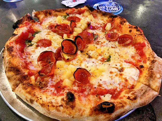 The Pepe Le Pineapple pizza dares to unite sweet and savory, with golden pineapple chunks playing tag with spicy pepperoni.