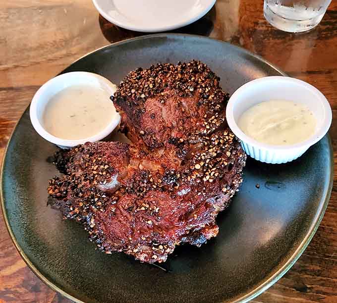 This pepper-crusted ribeye looks like it just won the steak lottery, with a crust so perfect it deserves its own standing ovation.
