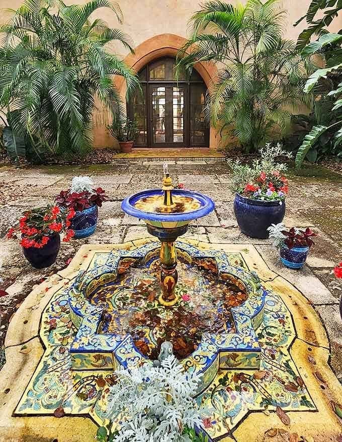 Pinewood Estate's courtyard fountain creates a Mediterranean oasis in central Florida, where intricate tilework meets tropical plantings in perfect harmony.