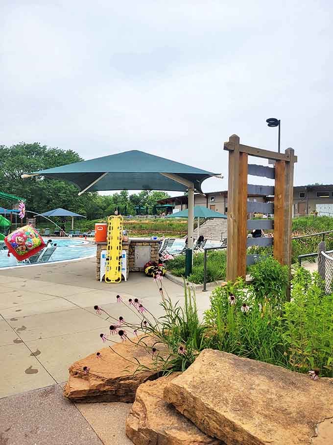 Shaded seating areas are strategically placed for parents who've mastered the art of relaxing while remaining technically on duty.