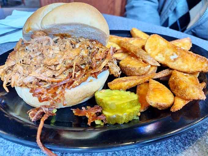 The pulled pork sandwich arrives looking deceptively simple but packs flavors that'll make your taste buds do a happy dance.