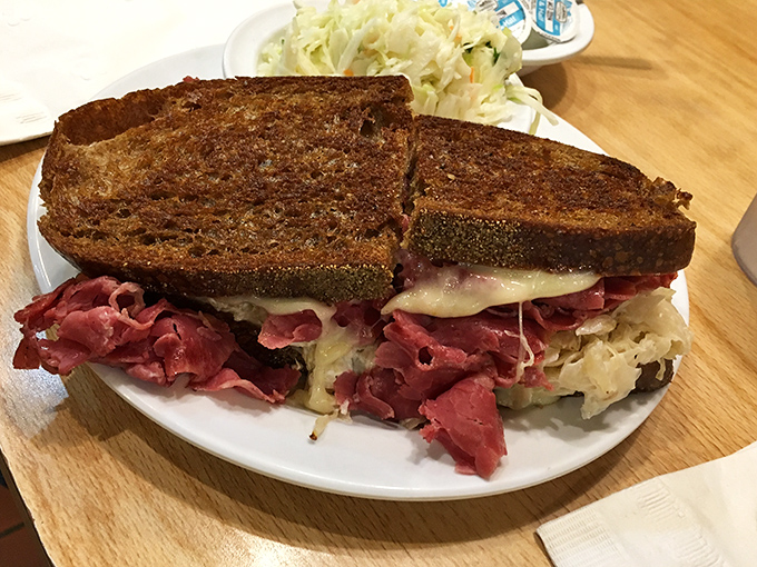 Behold the legendary Reuben – an architectural marvel of tender corned beef, tangy sauerkraut, and melted Swiss on perfectly grilled rye.