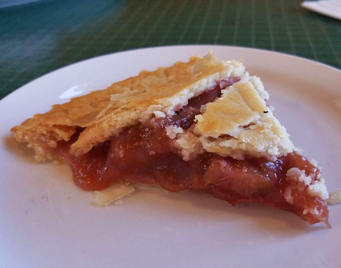 Ruby-red filling peeks through a golden lattice crust, promising that perfect sweet-tart balance that has made Berry's rhubarb pie the stuff of local legend.