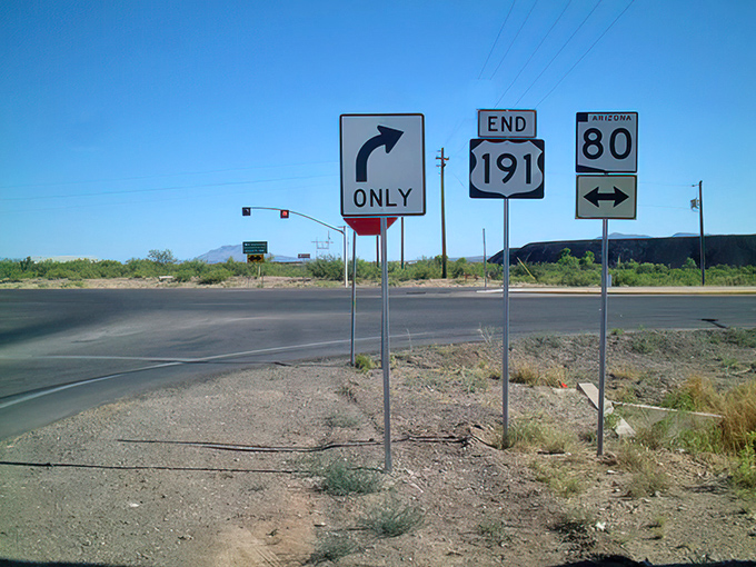 Road signs stand sentinel at a crucial junction, silently guiding travelers through Arizona's diverse landscapes with simple arrows and numbers.
