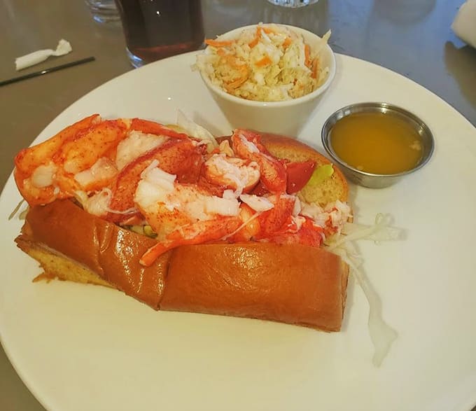 Behold the Connecticut-style perfection: warm, buttery lobster chunks nestled in a golden-toasted bun that's basically edible architecture at its finest.