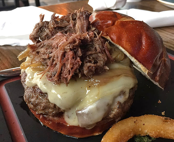 The Short Rib Burger towers like a delicious skyscraper, requiring both hands and possibly an engineering degree to navigate successfully.