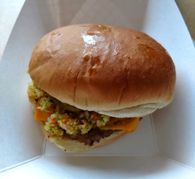 Behold the star of the show: a perfectly crafted burger where the marriage of beef and tangy slaw creates a symphony of flavors.