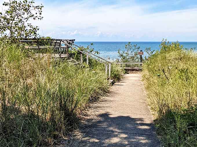 Sandy pathways through swaying dune grass create nature's perfect invitation to Lake Huron's refreshing embrace.