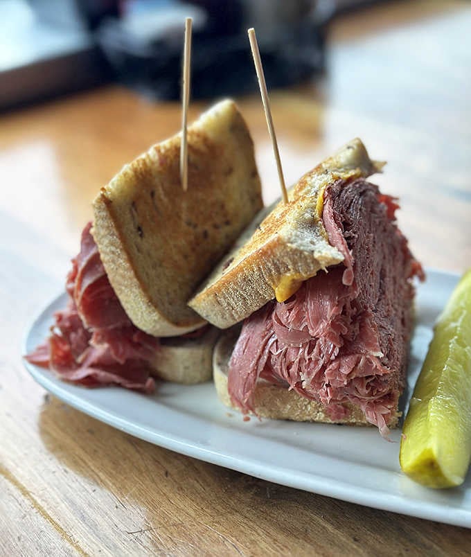 Not just a sandwich, but a skyscraper of perfectly seasoned corned beef &ndash; architectural marvel meets culinary masterpiece.